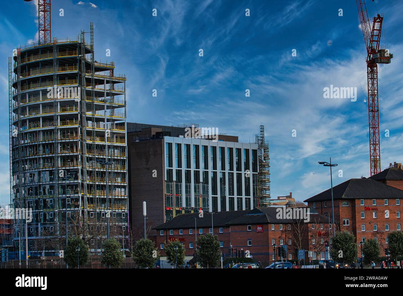 Urban construction site with cranes and developing high-rise building ...