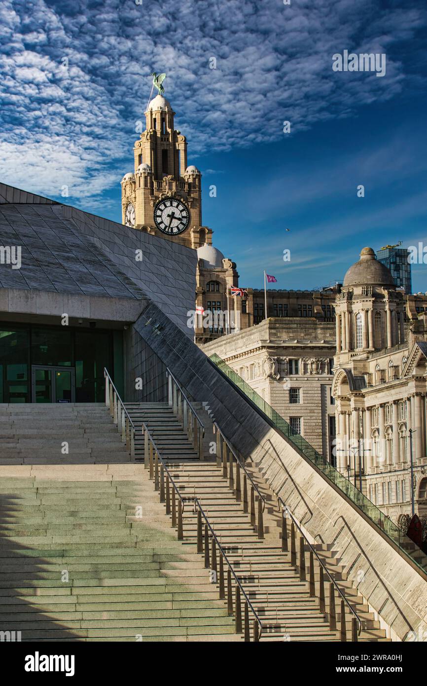 Modern staircase leading to historic clock tower under a blue sky with ...