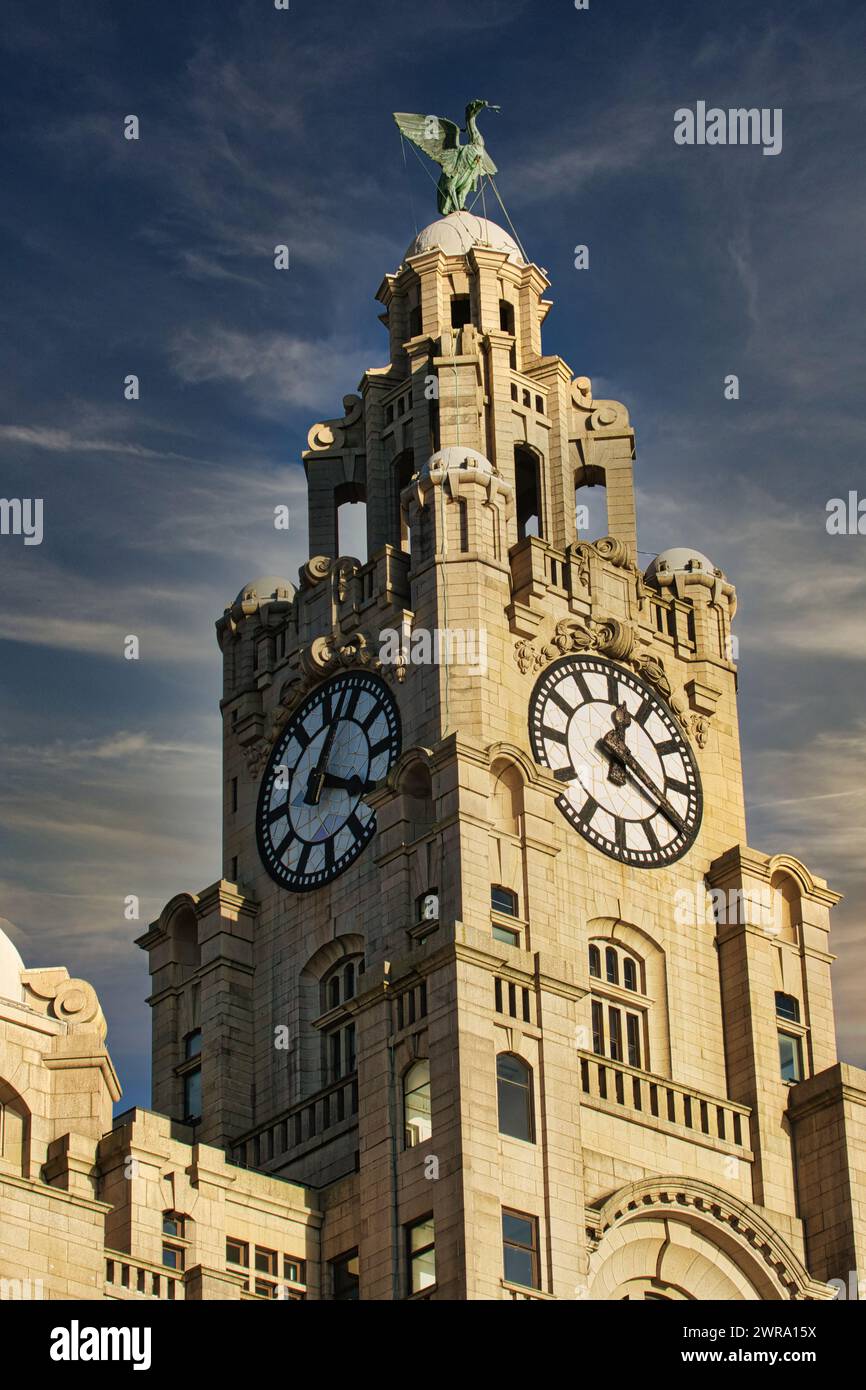 Historic clock tower against a blue sky with clouds, architectural ...