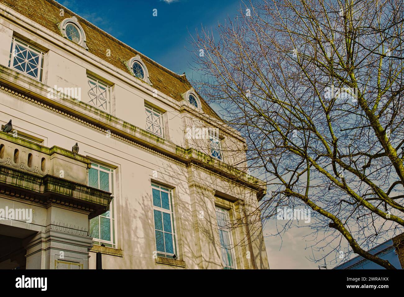 Elegant vintage building facade with blue windows under a clear sky ...