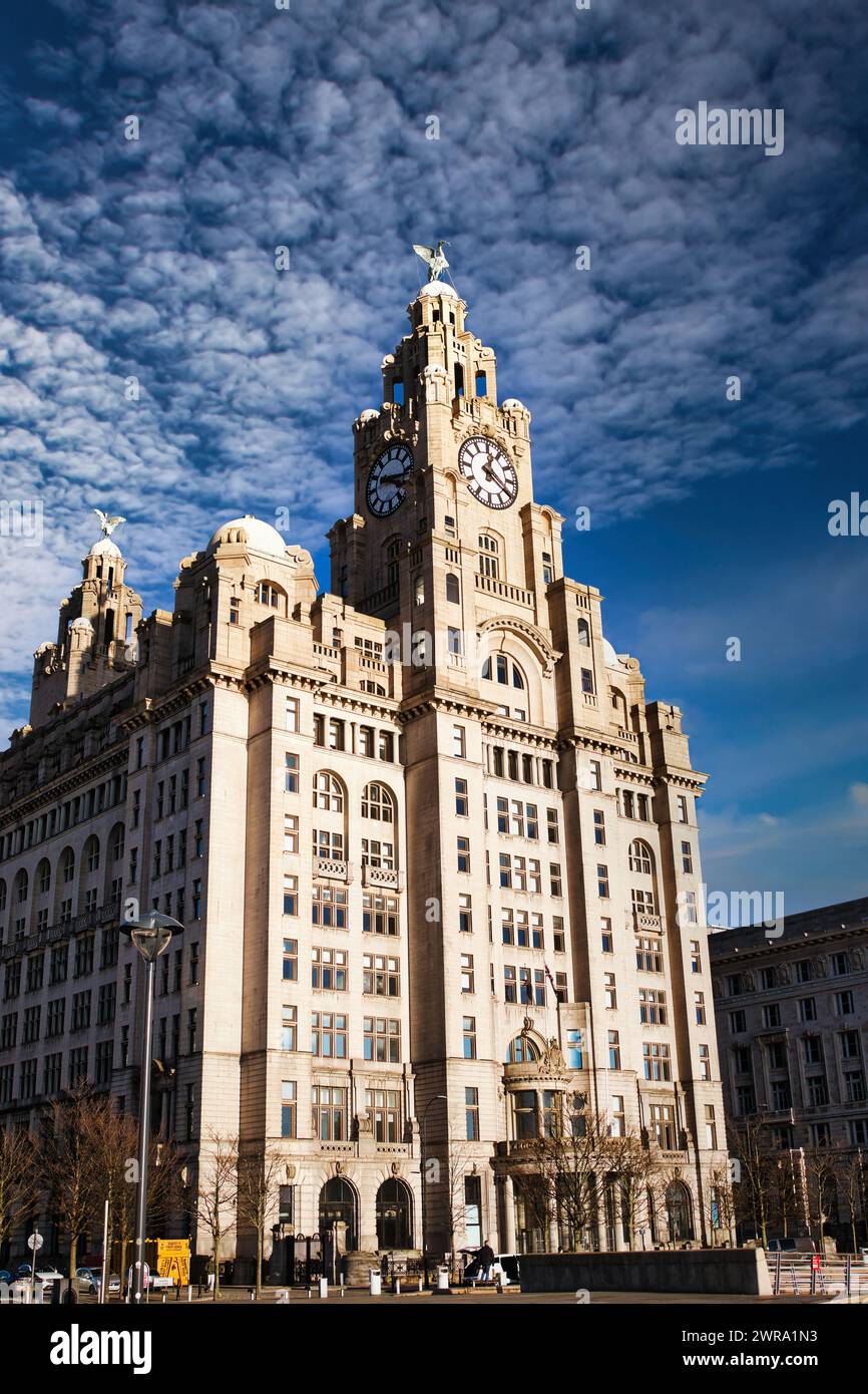 Historic clock tower building against a blue sky with clouds in ...