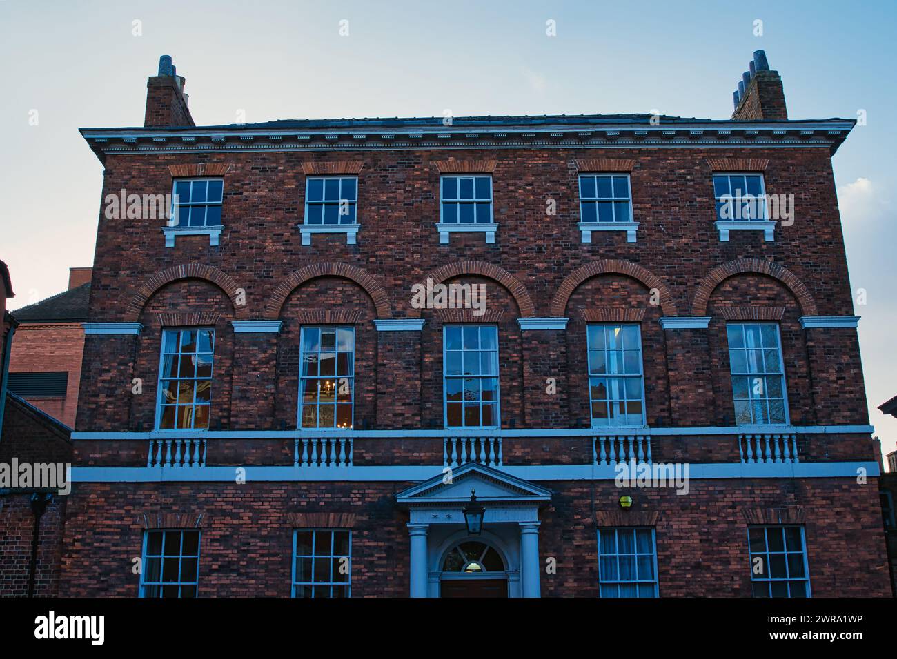 Traditional brick building facade under blue sky at dusk in York, UK ...