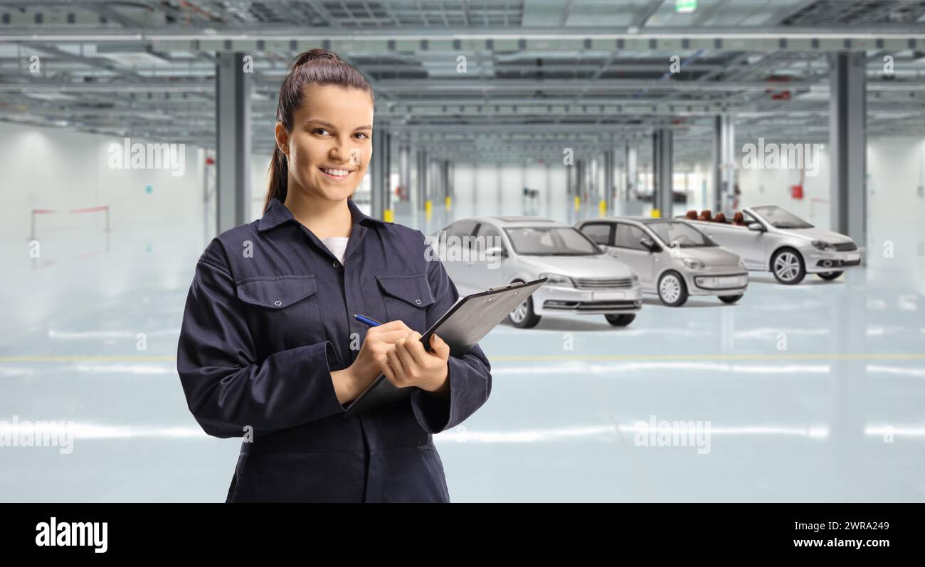 Female garage worker in a uniform holding a clipboard Stock Photo - Alamy