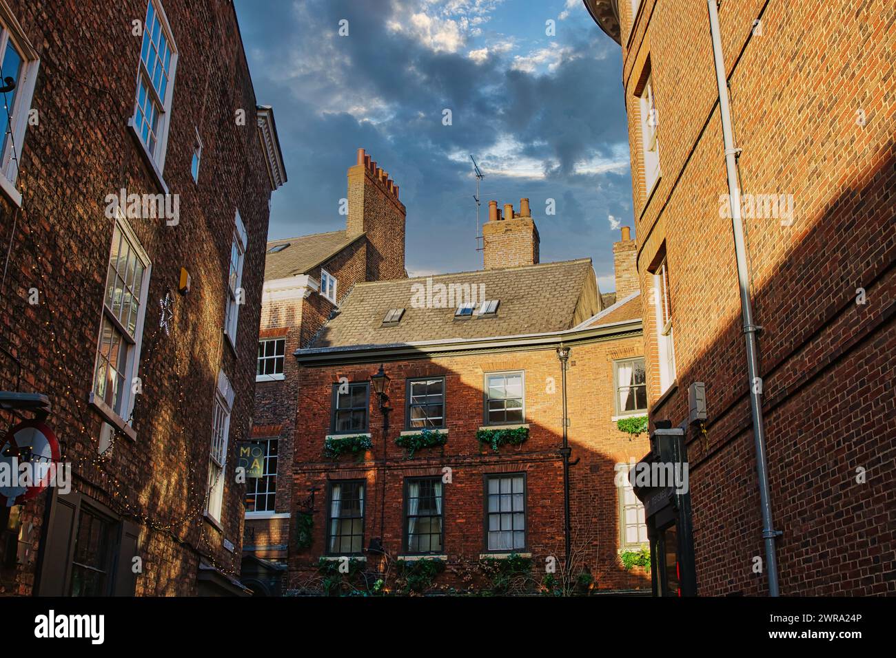 Charming European alleyway with historic brick buildings and a glimpse ...