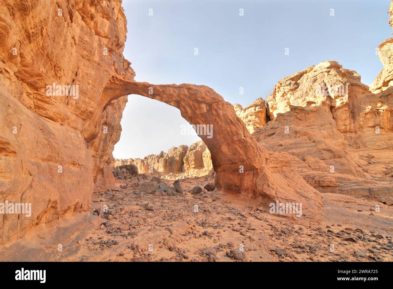 A natural arch formed in sandstone in the Sahara Desert in Algeria ...