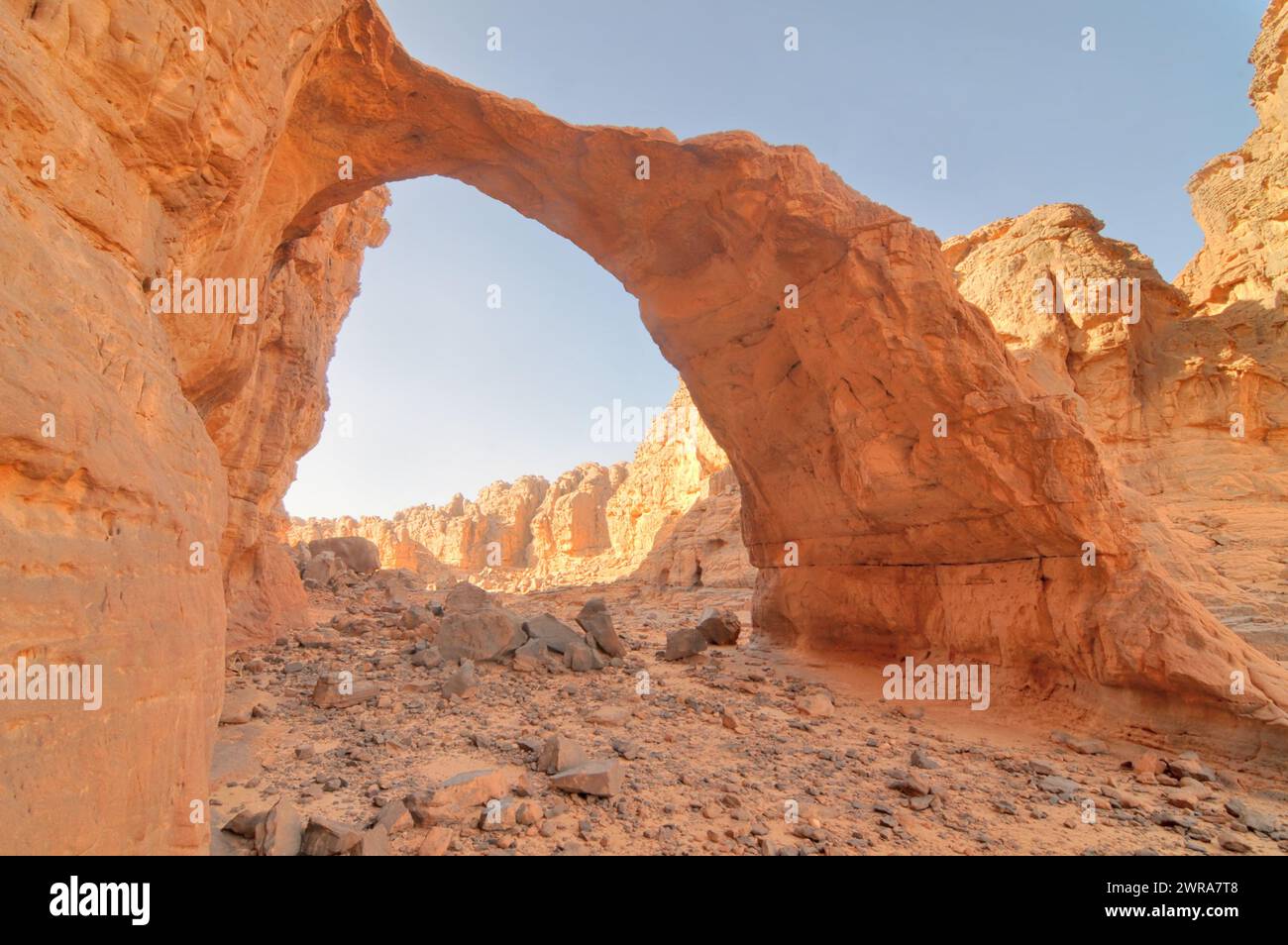 A natural arch formed in sandstone in the Sahara Desert in Algeria ...