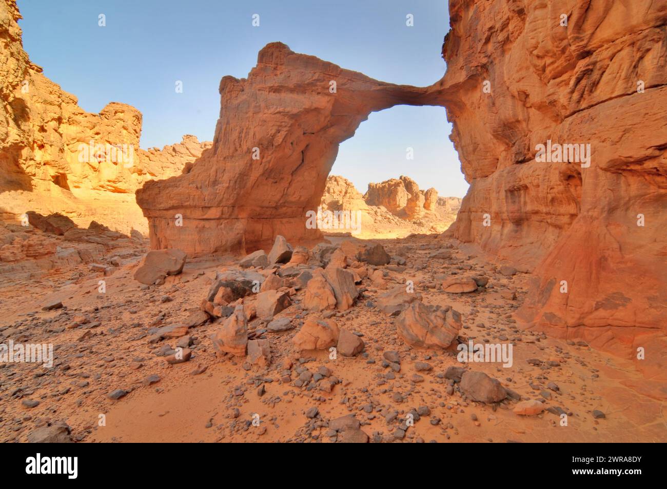 A natural arch formed in sandstone in the Sahara Desert in Algeria ...