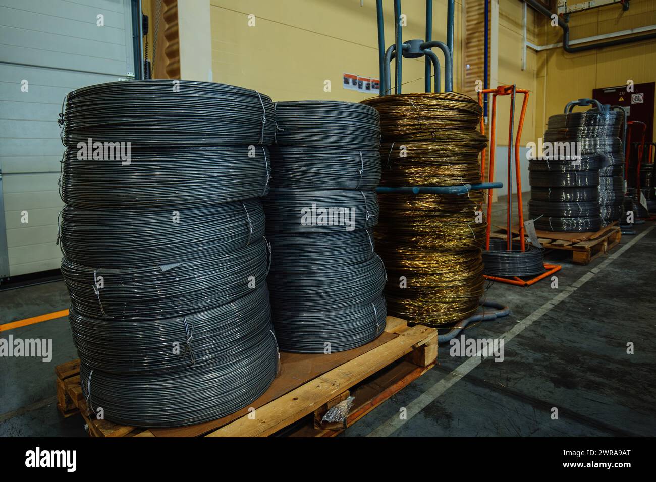 Steel wire coils in metalworking factory Stock Photo - Alamy