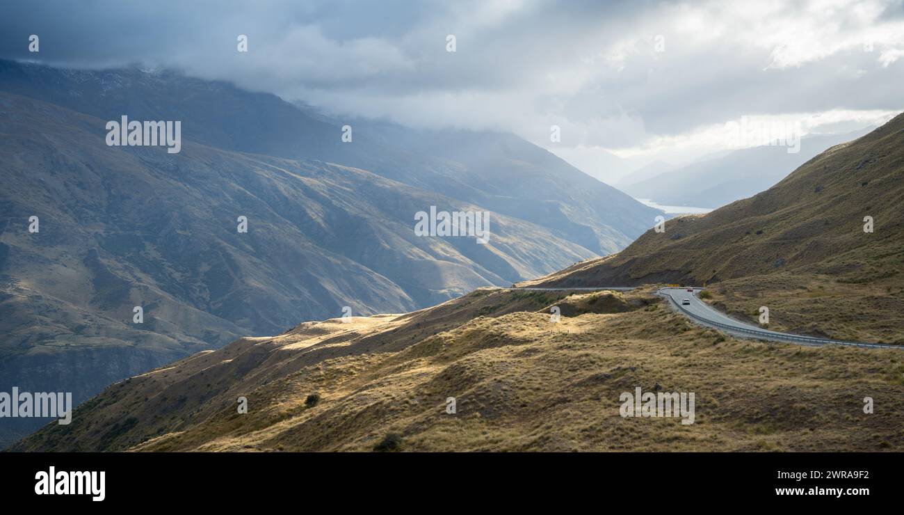 Cars passing curvy road leading through mountains pass in alpine ...