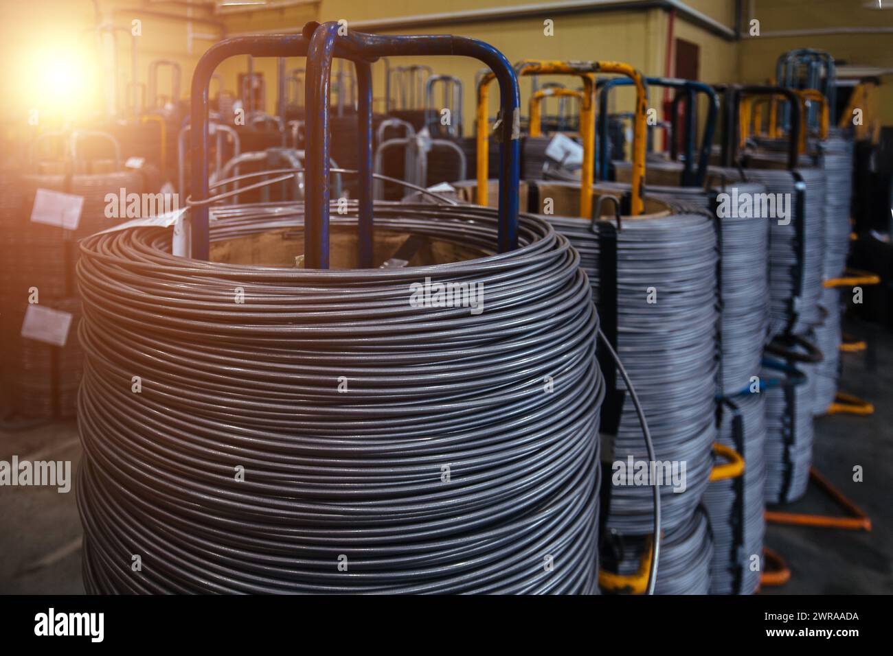 Steel wire coil in metalworking factory Stock Photo - Alamy