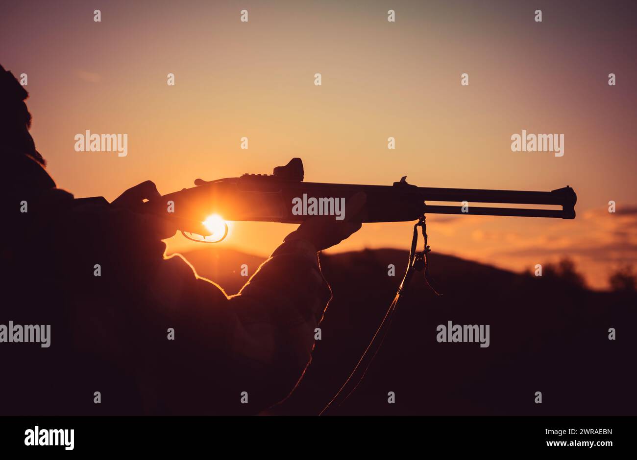 Calibers of hunting rifles. Rifle Hunter Silhouetted in Beautiful ...