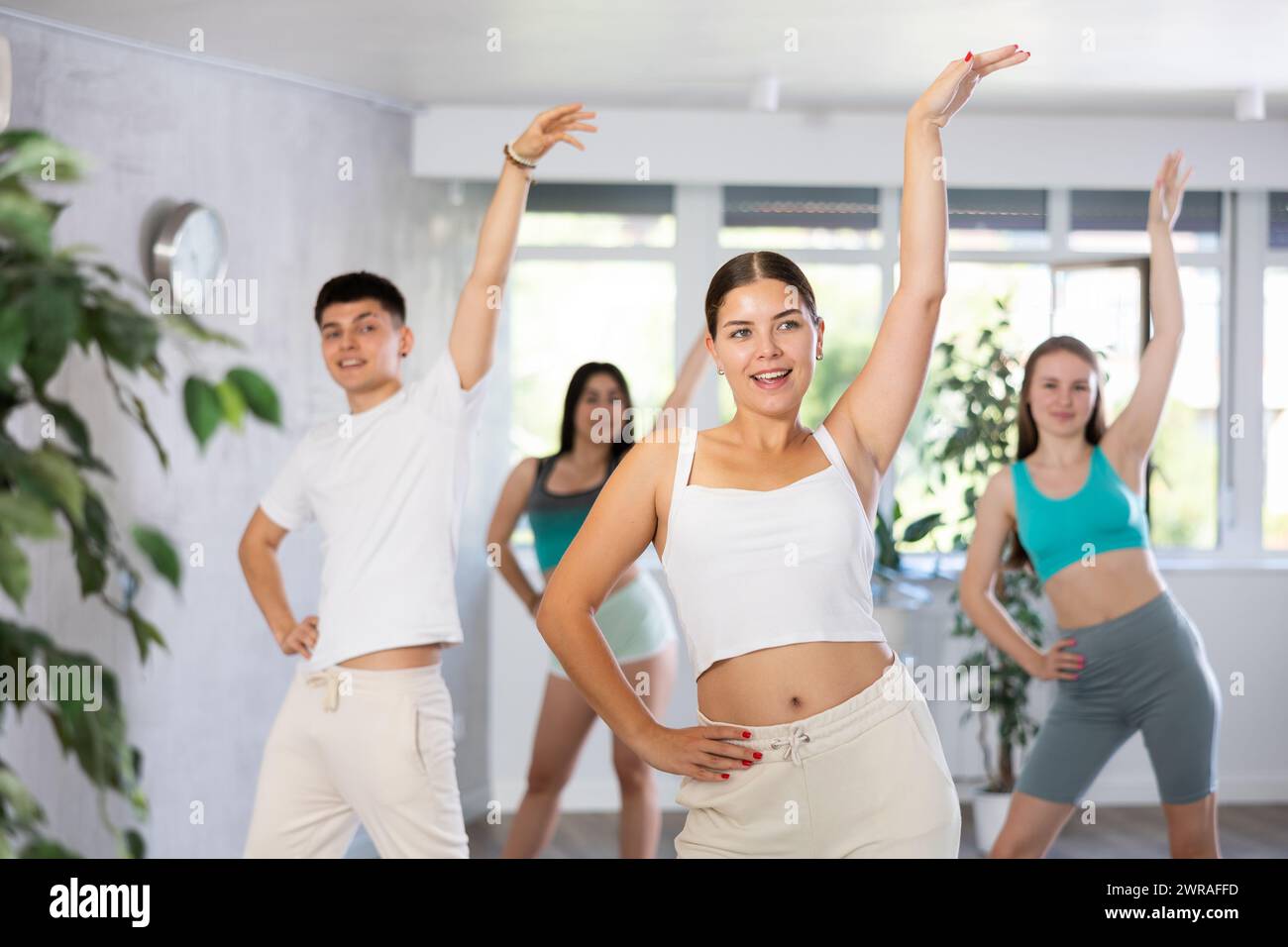 Group of energetic girls and guys learning dance at class Stock Photo ...