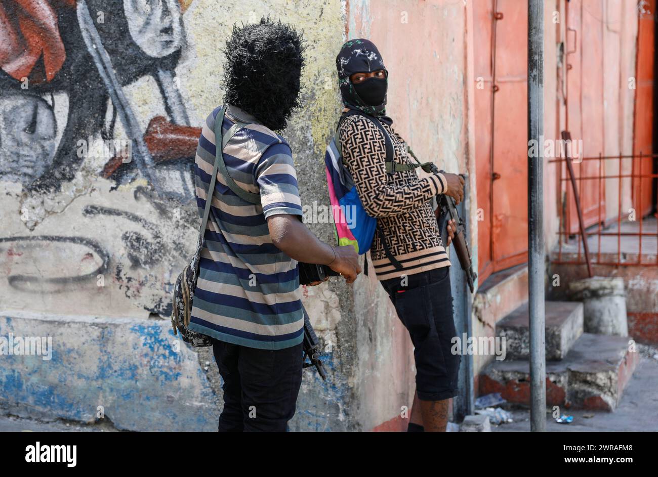 Members of the G9 and Family gang speak to each other while standing ...