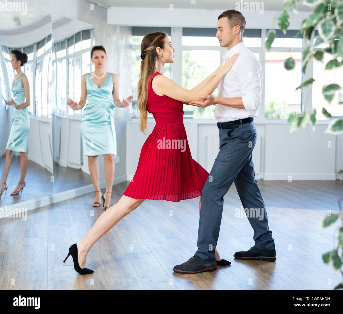 Couple in stage costumes learns waltz dancing during individual lesson ...