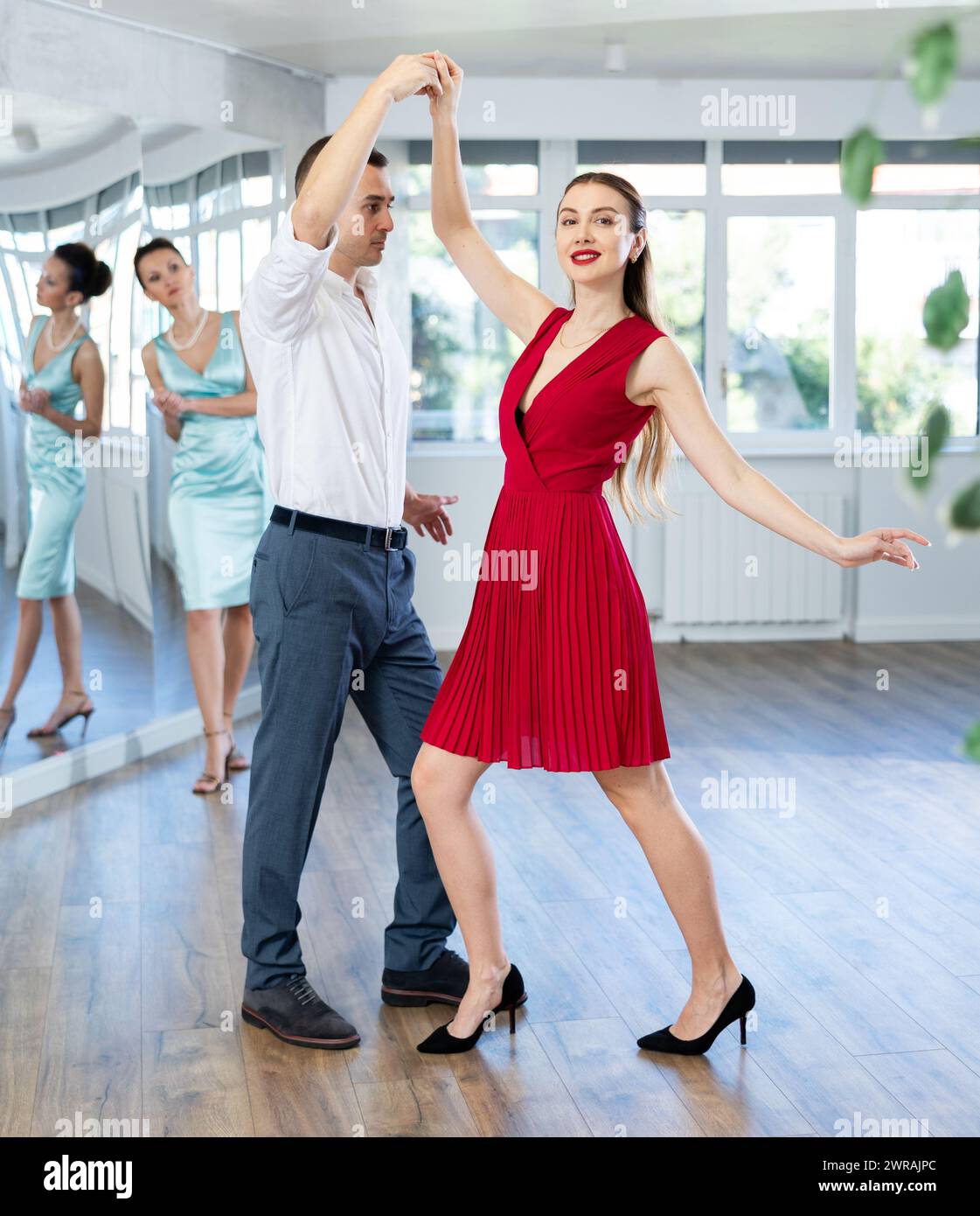 Couple in stage costumes learns boogie woogie dancing during individual ...