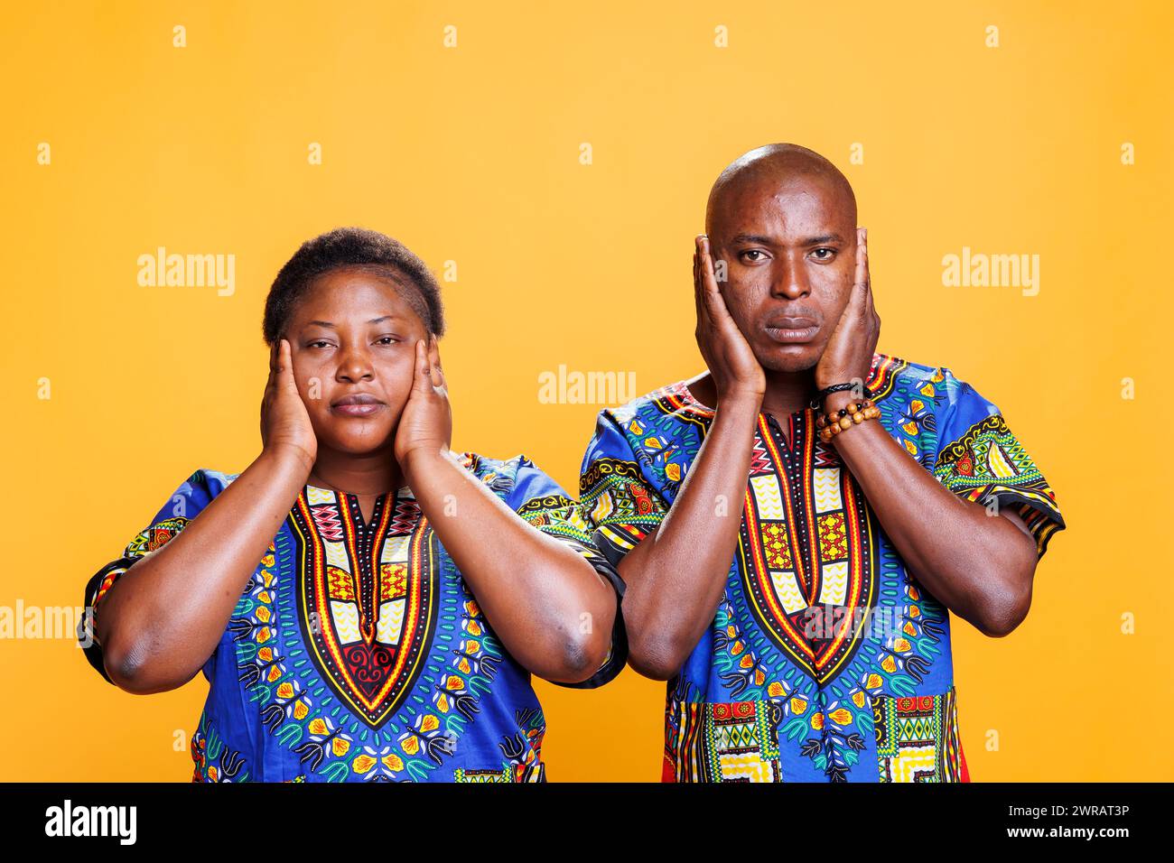 African american couple covering ears with hands, showing hear no evil ...