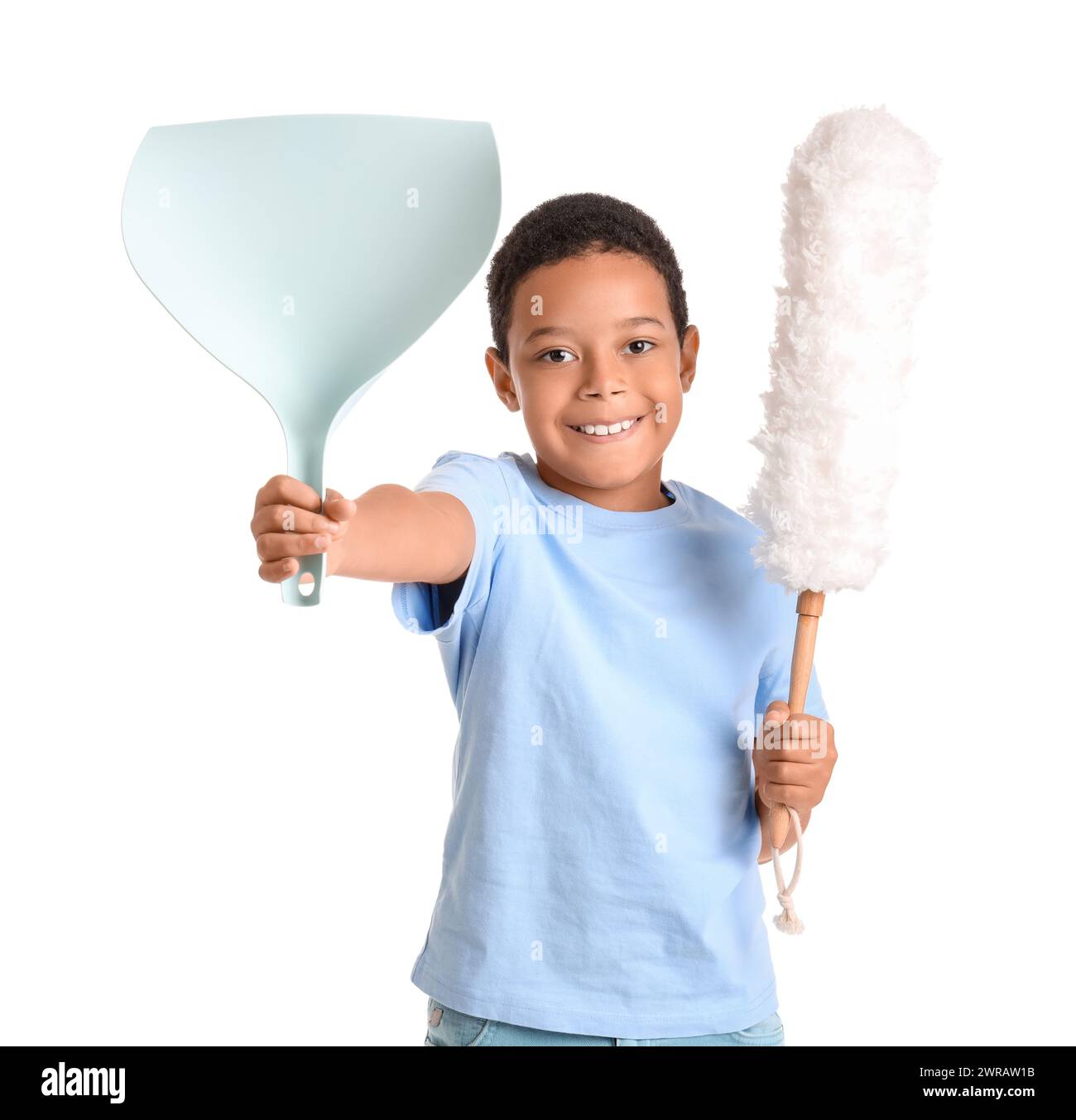 Little African-American boy with cleaning supplies on white background ...