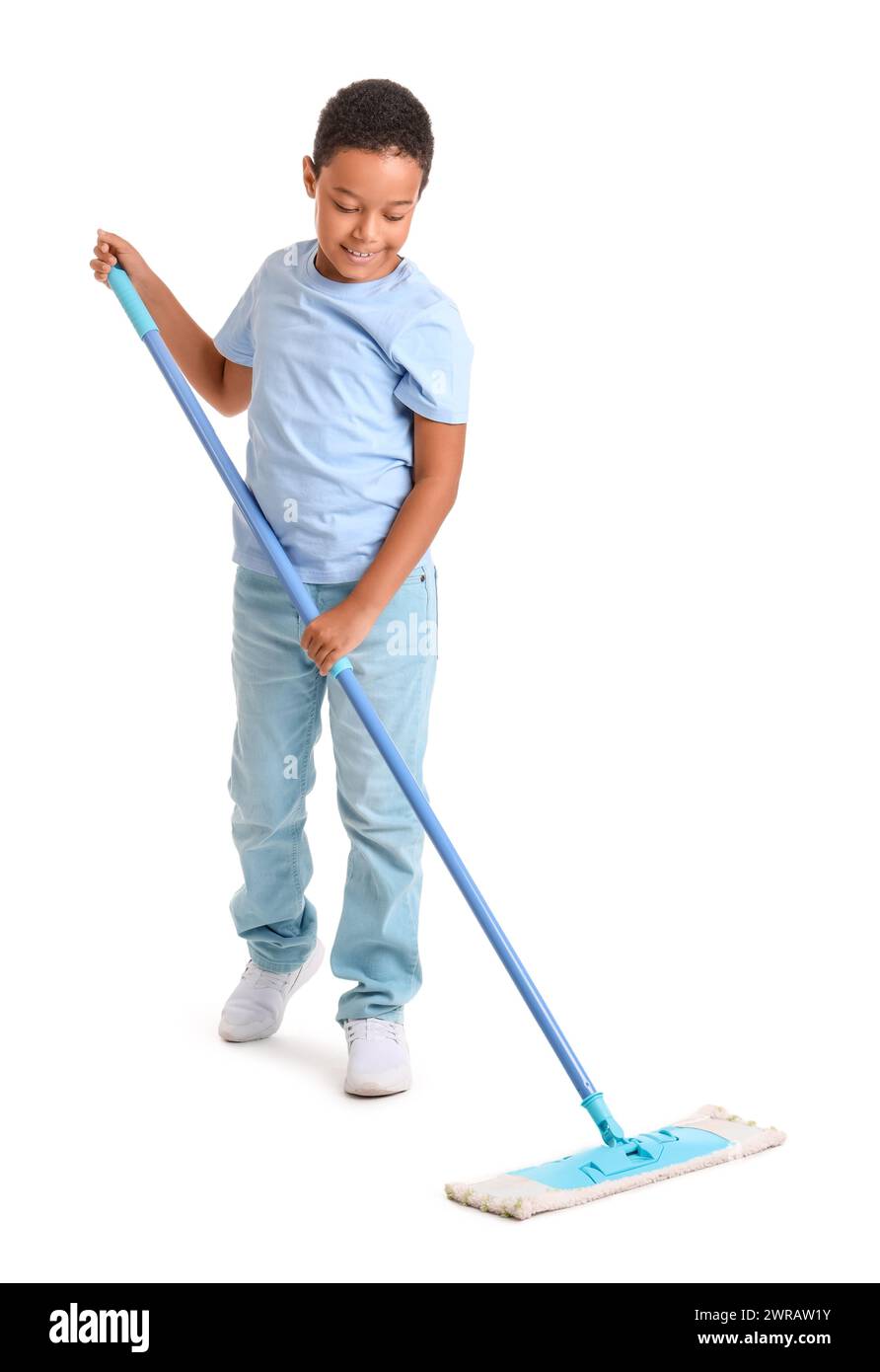 Cute little African-American boy mopping floor on white background ...
