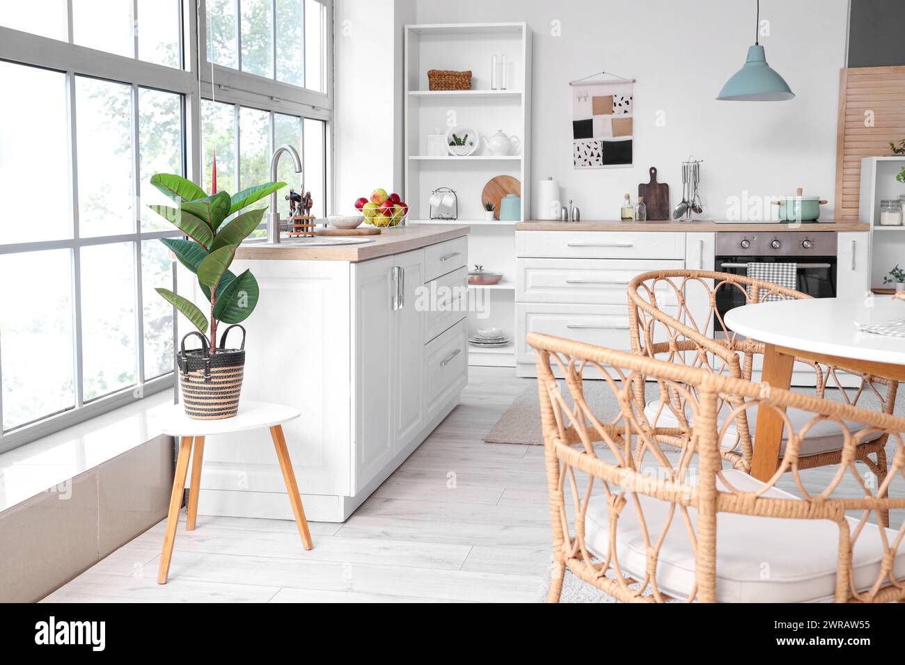 Interior of kitchen with counters and dining table Stock Photo - Alamy