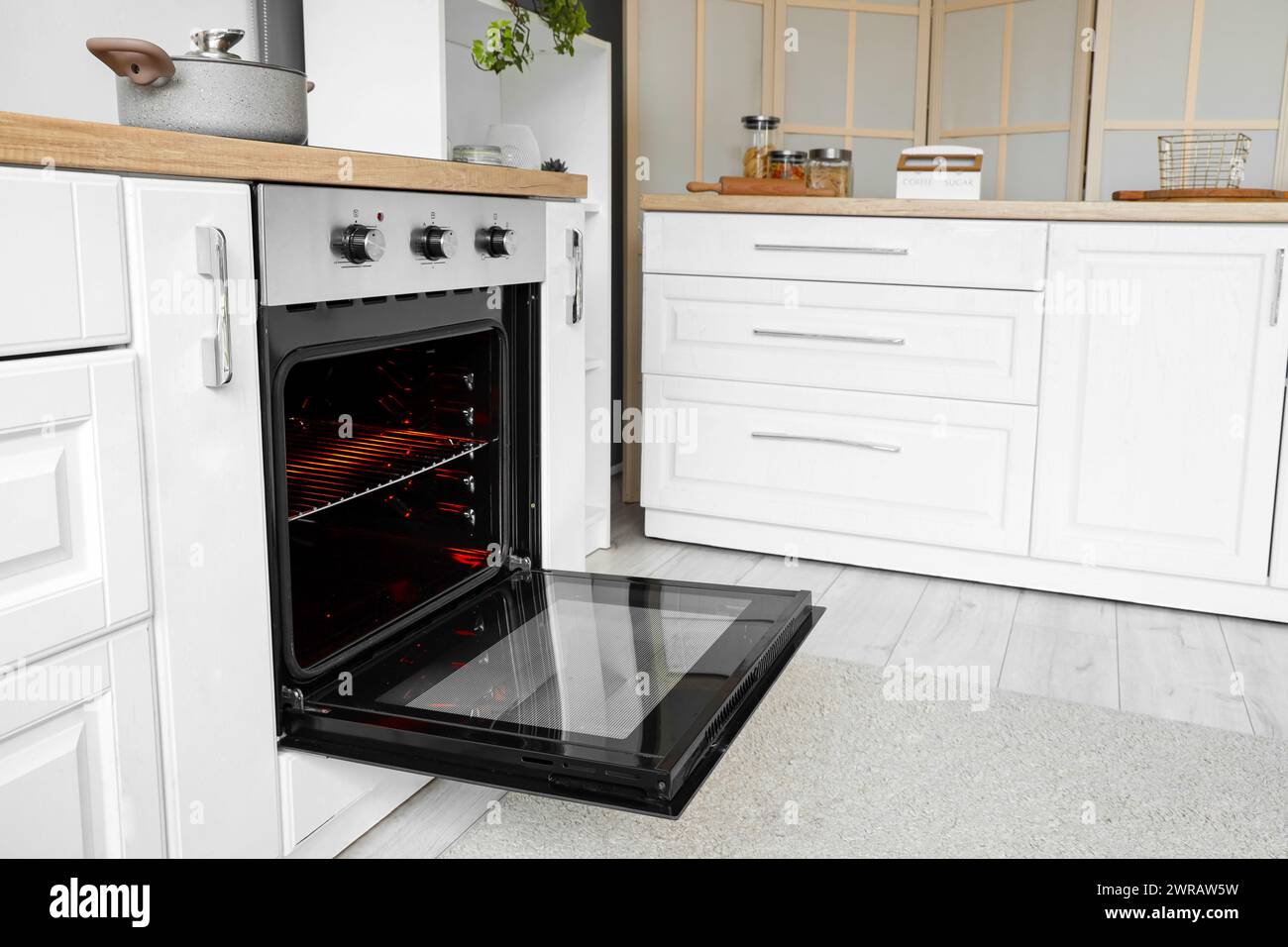 Interior of kitchen with white counters and oven Stock Photo - Alamy