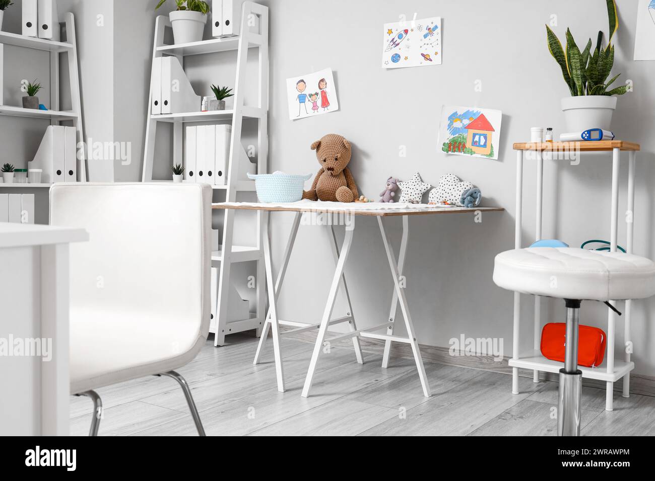 Interior of pediatrician's office with table and children's drawings ...