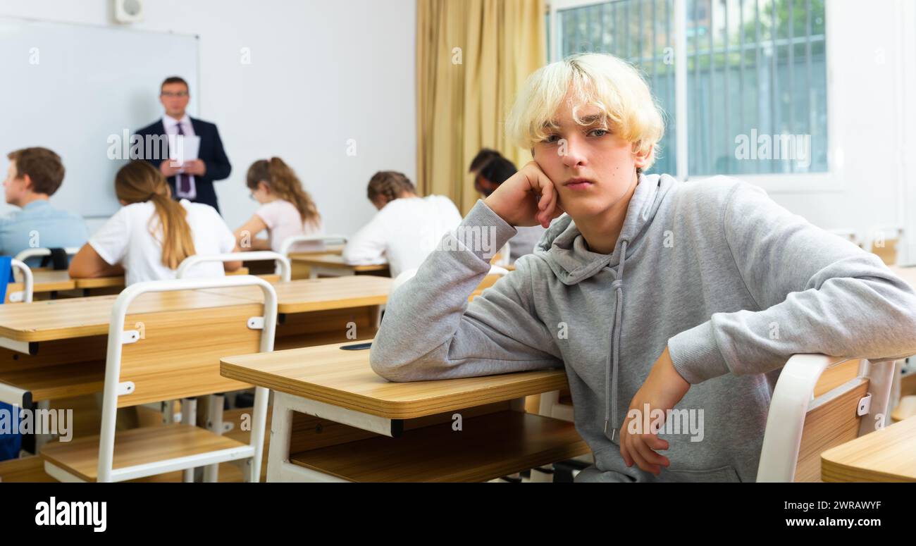 Portrait of tired student in school class Stock Photo - Alamy