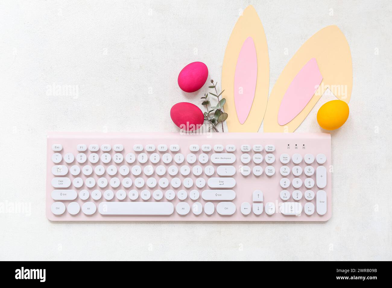 Composition with modern keyboard, Easter eggs and paper bunny ears on ...