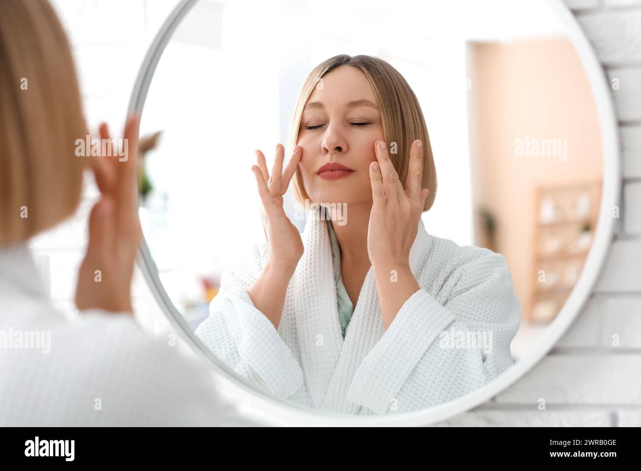 Woman doing face building exercise in bathroom Stock Photo - Alamy