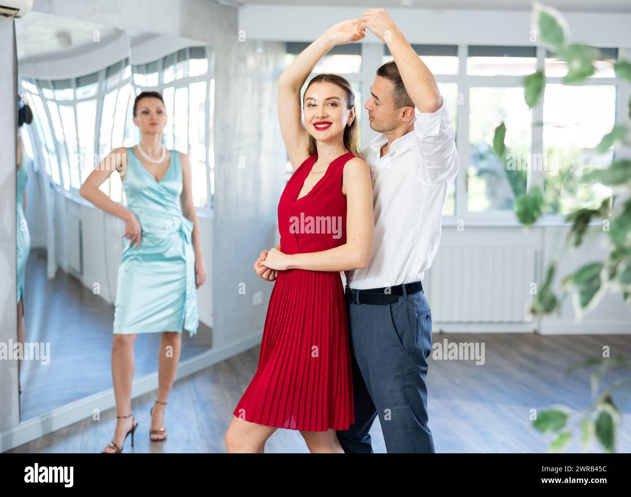 Couple in stage costumes learns waltz dancing during individual lesson ...