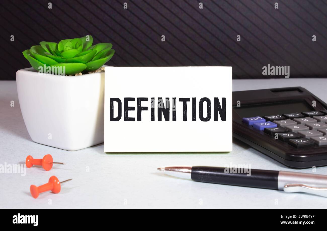 On a light gray background lies a pen, a green notebook and a white ...