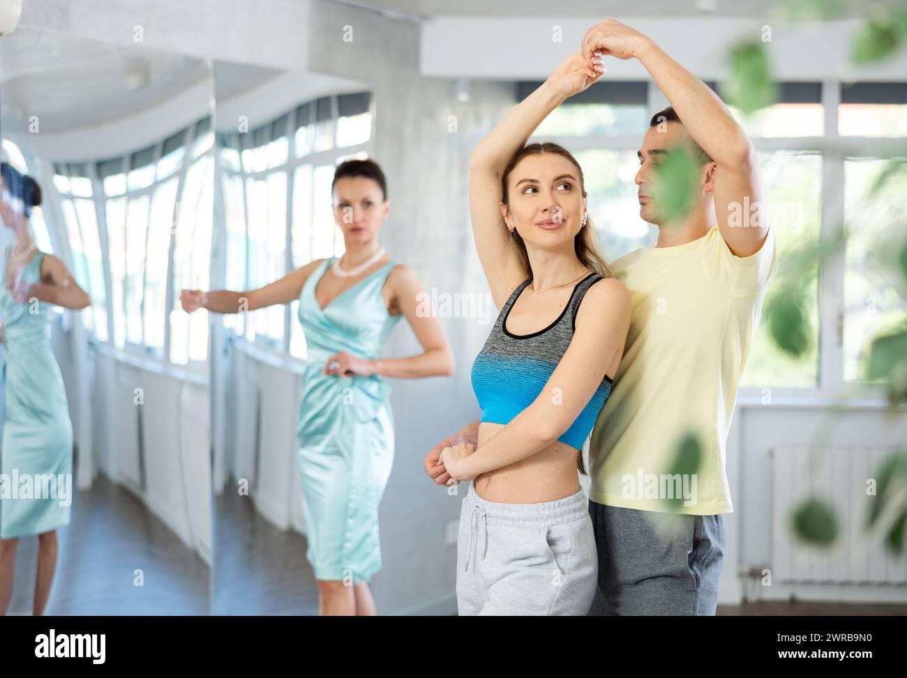 Couple in comfortable sports clothes waltz dancing during individual ...