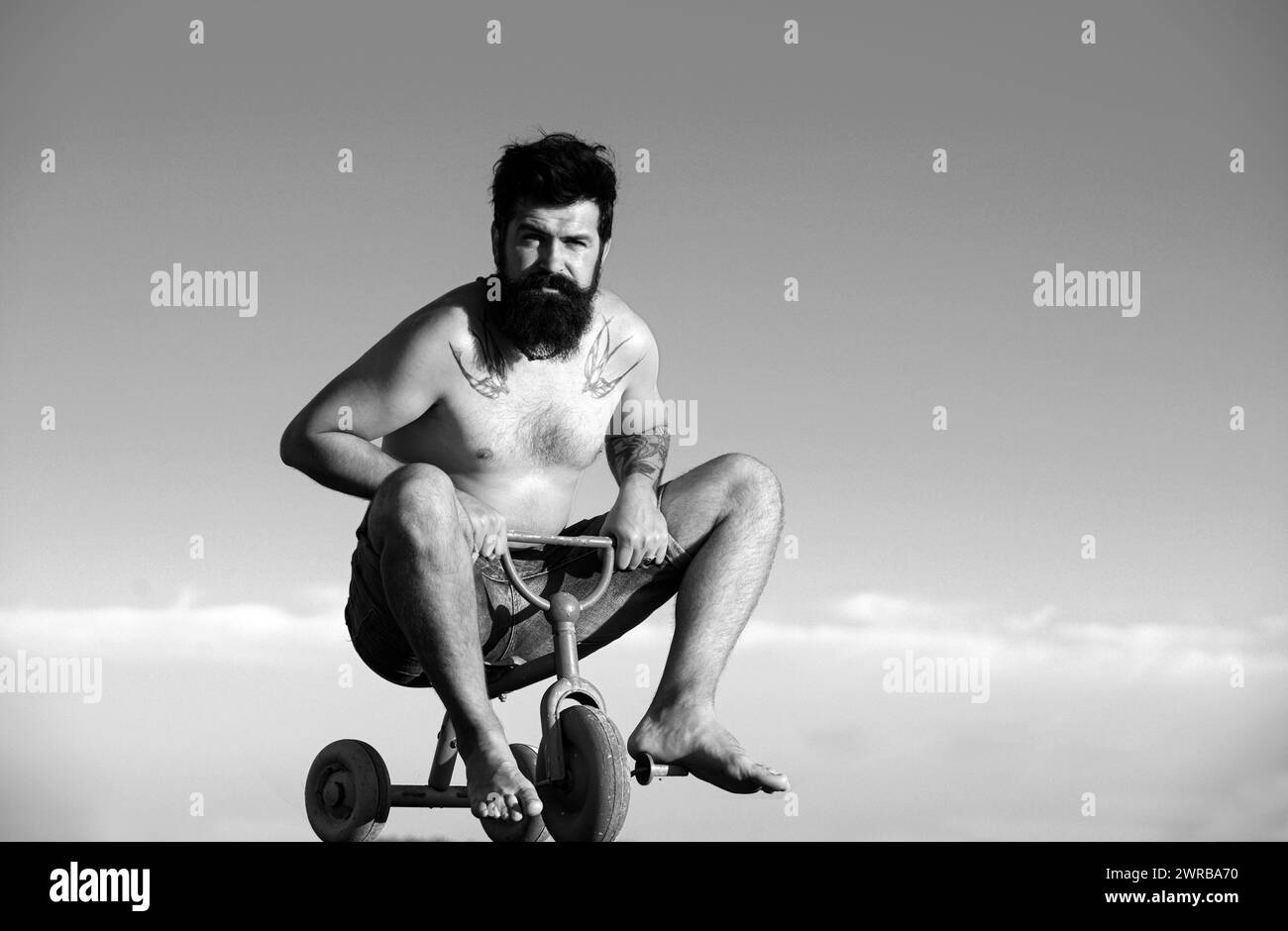 Funny biker. Crazy man riding a small bicycle Stock Photo - Alamy