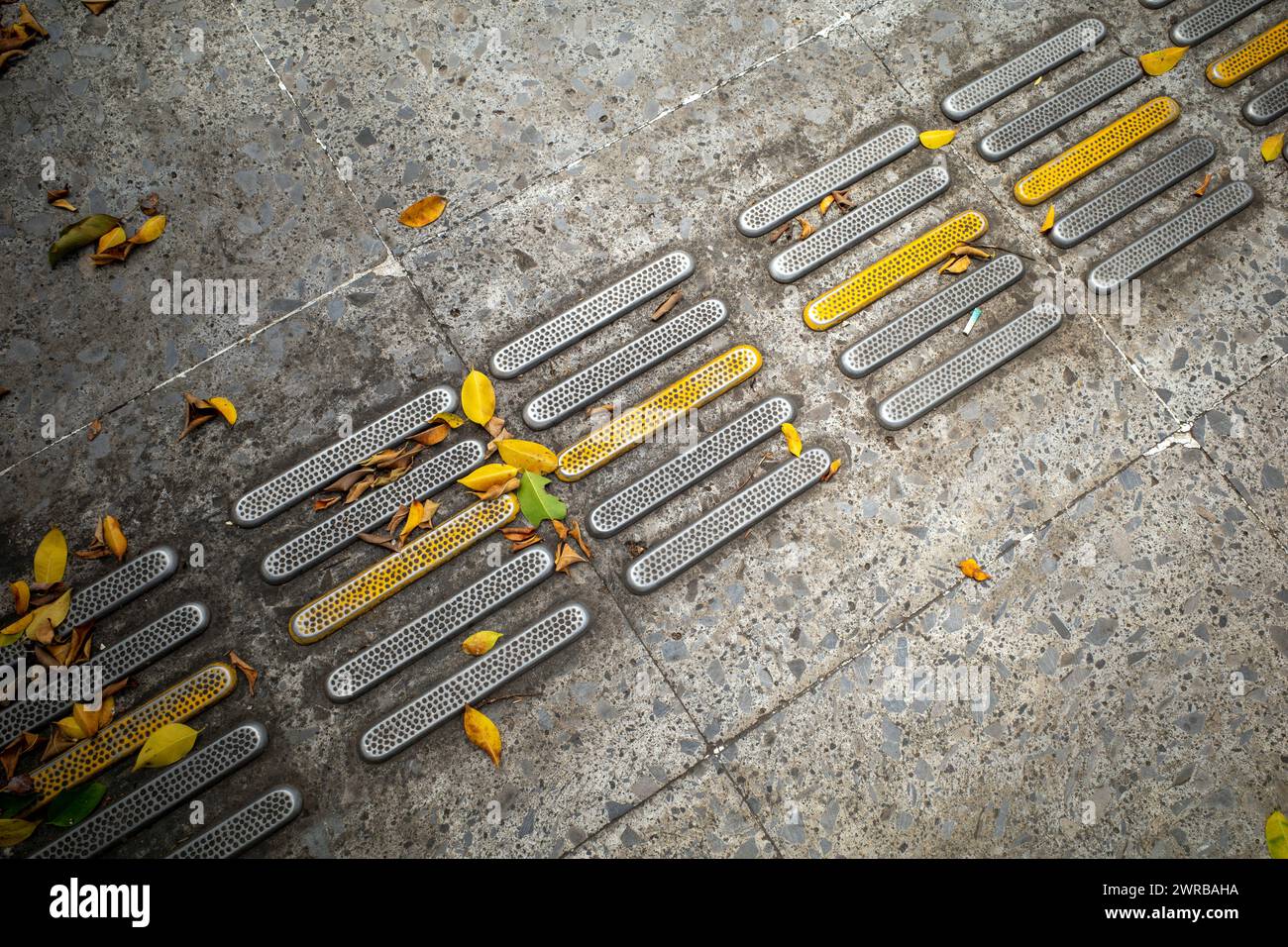 Yellow tactile paving for blind people or visually impaired with dry ...