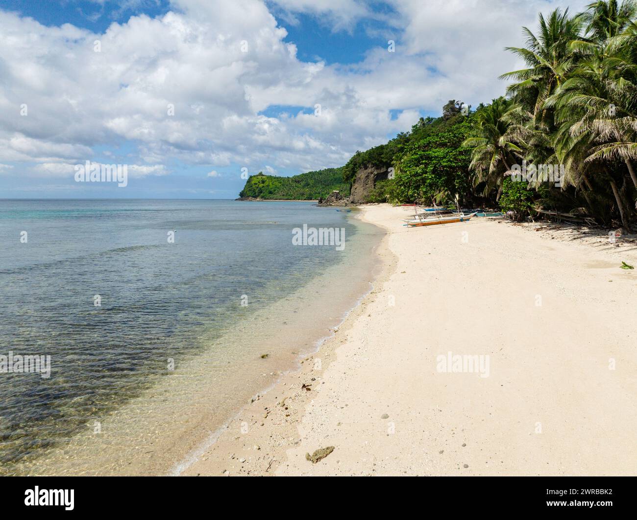 Tropical white sandy beach in Santa Fe. Blue sky and clouds. Tablas ...
