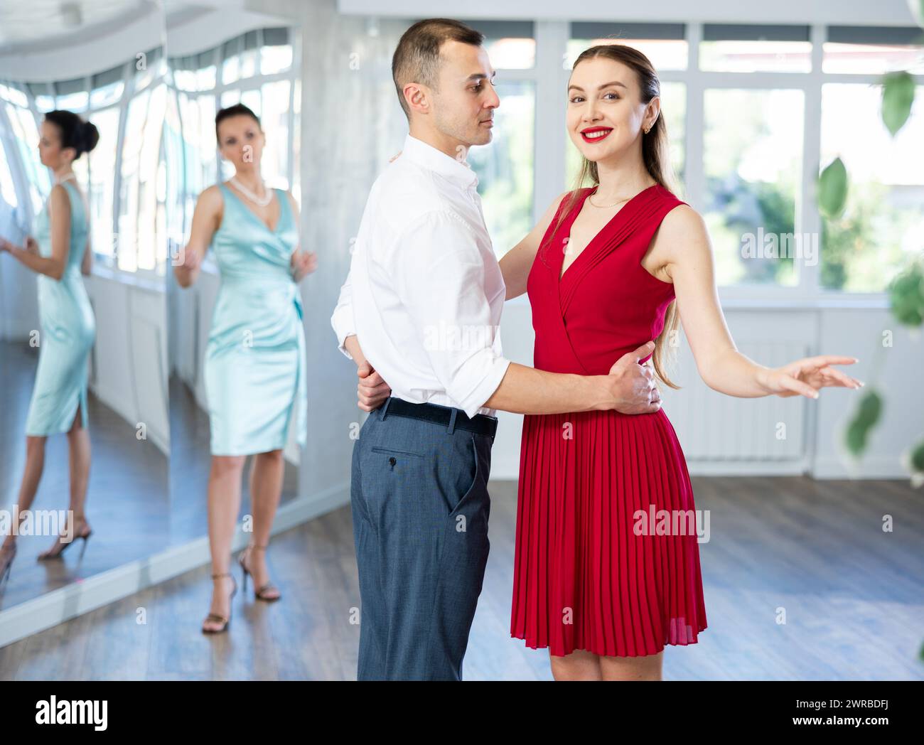 Couple in stage costumes learns waltz dancing during individual lesson ...