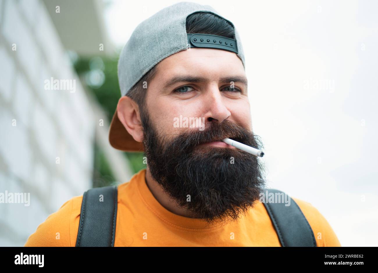 Handsome guy smoking outside in urban. Man smoking cigarette Stock ...