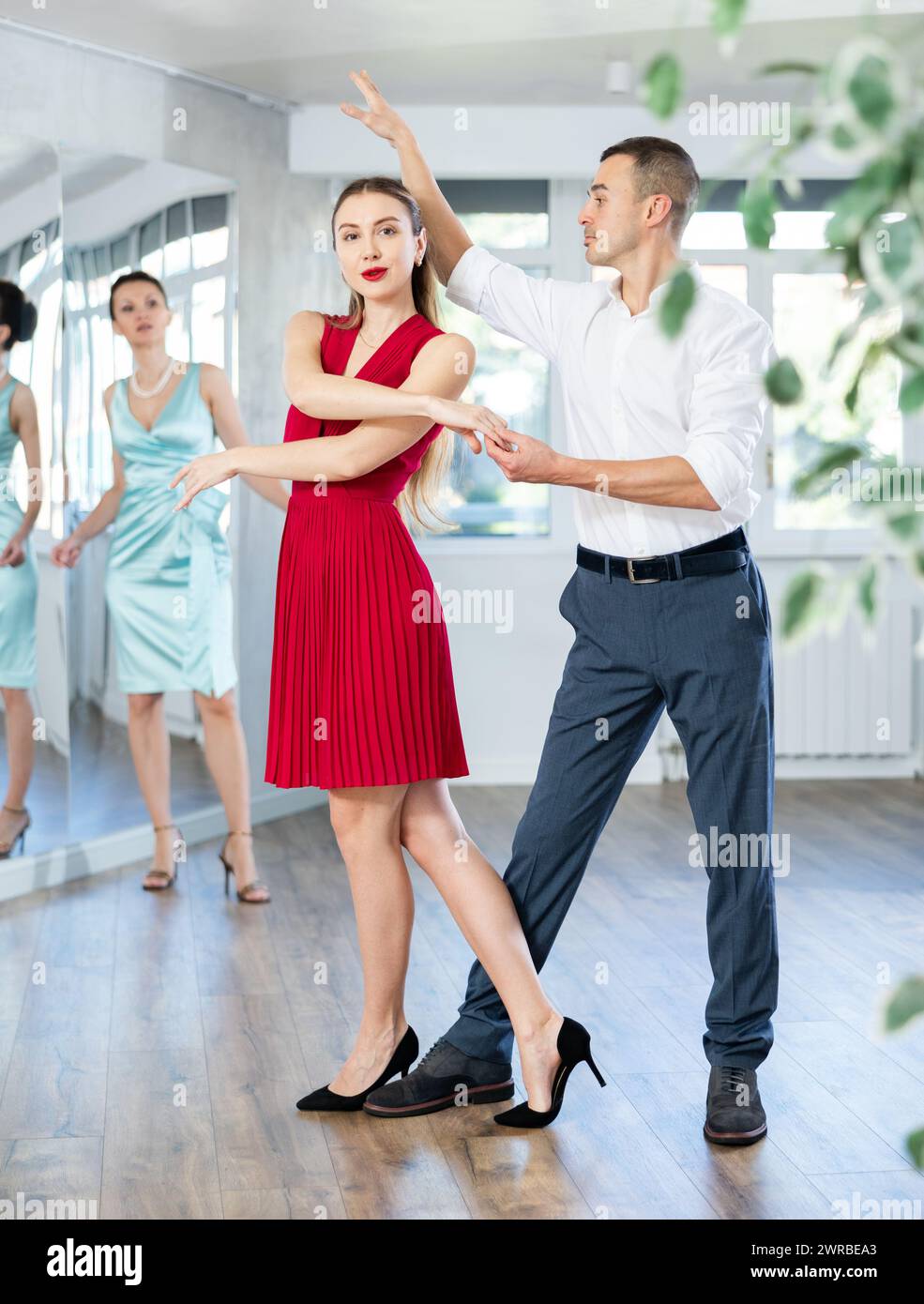 Couple in stage costumes learns waltz dancing during individual lesson ...