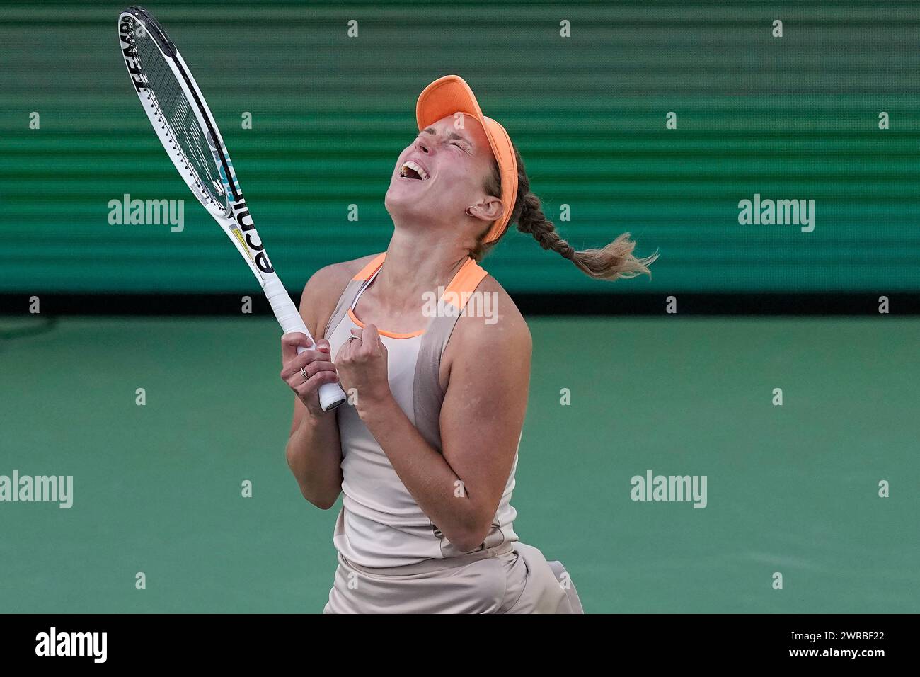 Elise Mertens, of Belgium, celebrates after defeating Naomi Osaka, of ...