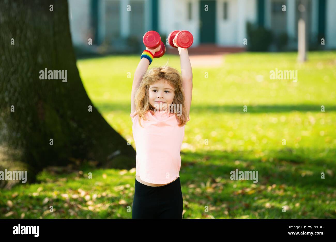 Fitness child. Sporty portrait kids. Fitness child with dumbbells in ...