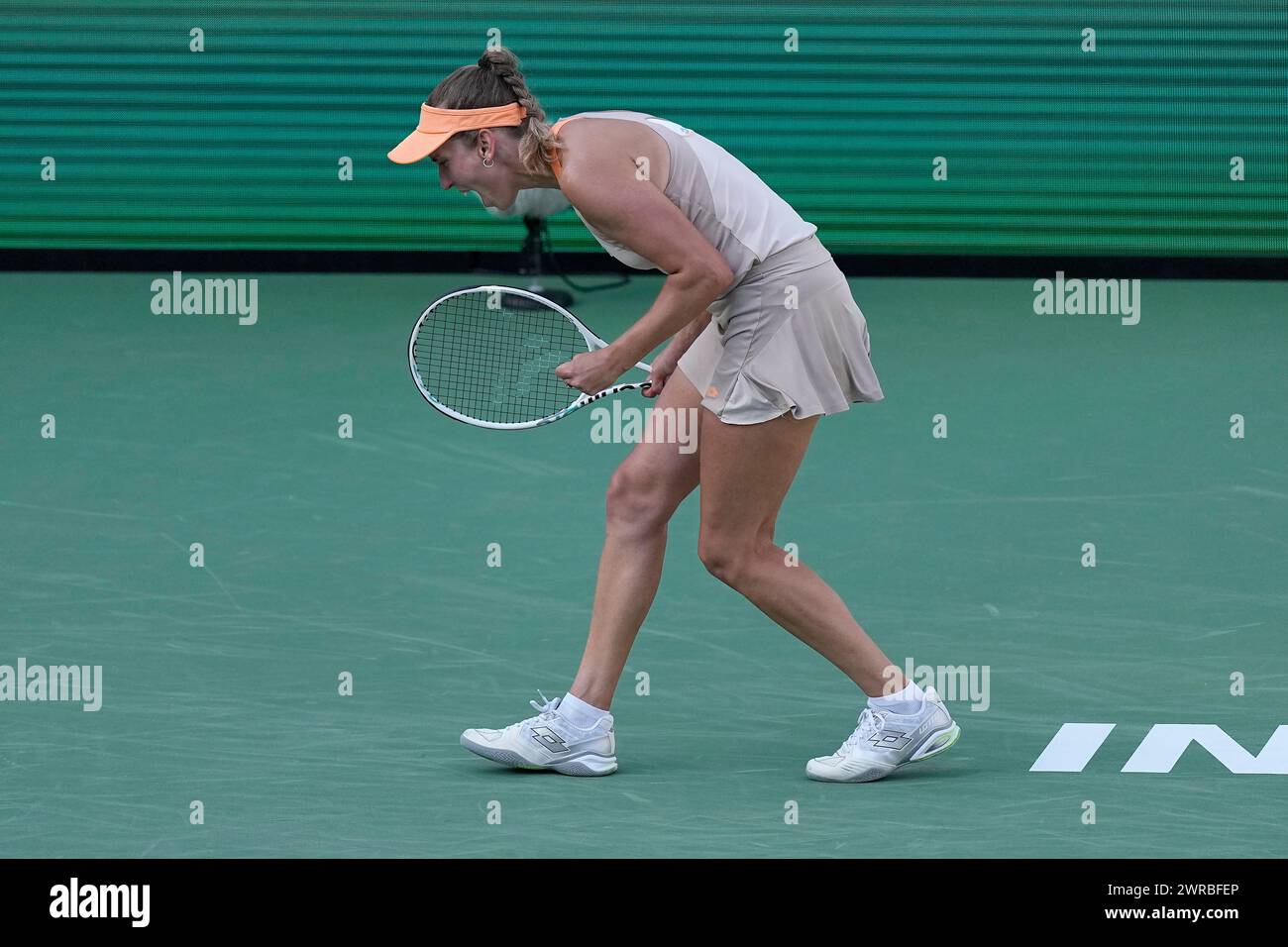 Elise Mertens, of Belgium, reacts after winning a point against Naomi ...