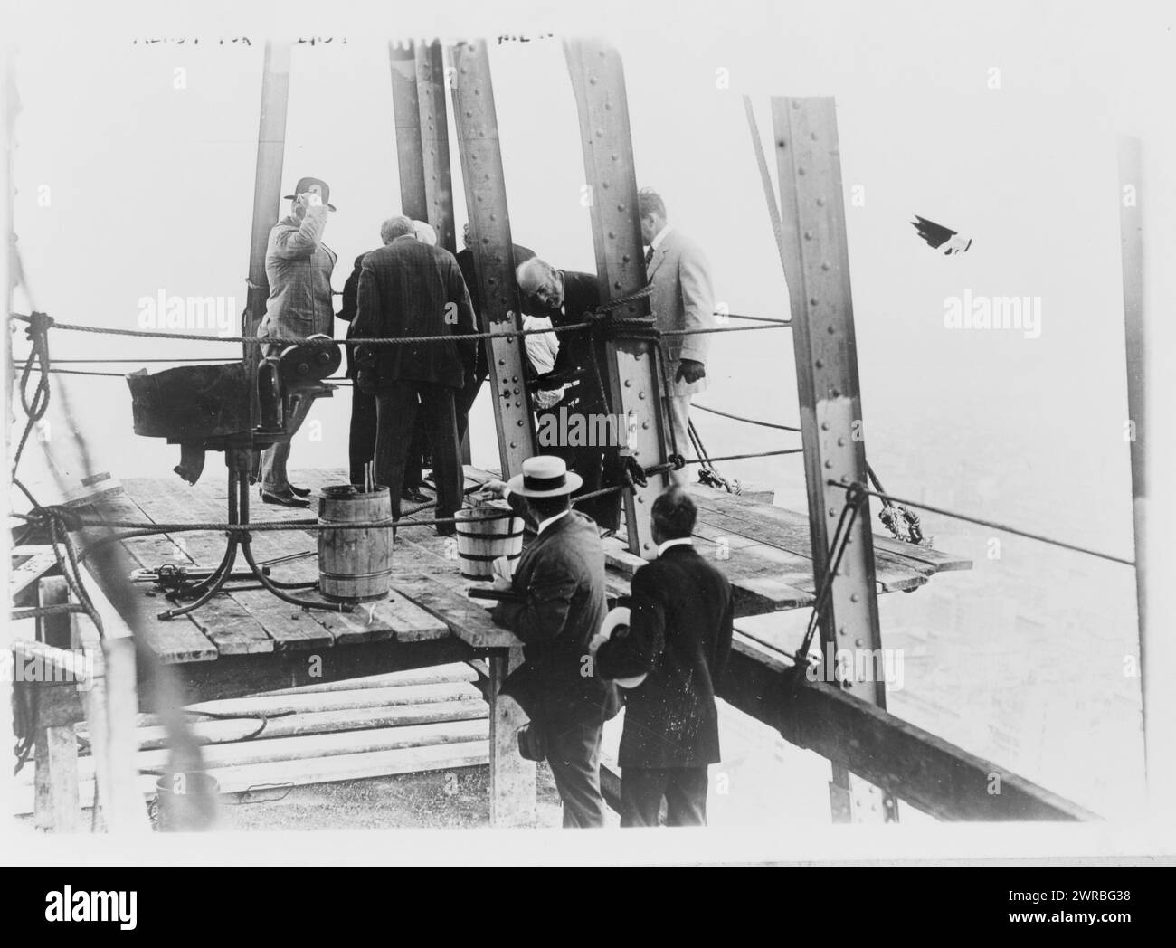 Insurance co. pres. John Rogers Hegeman driving last rivet ...