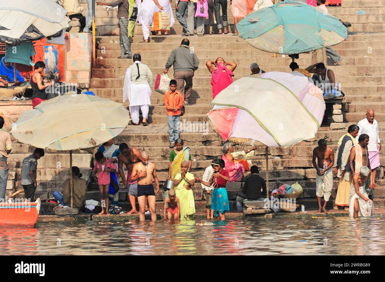 People going about daily activities such as bathing and washing clothes ...