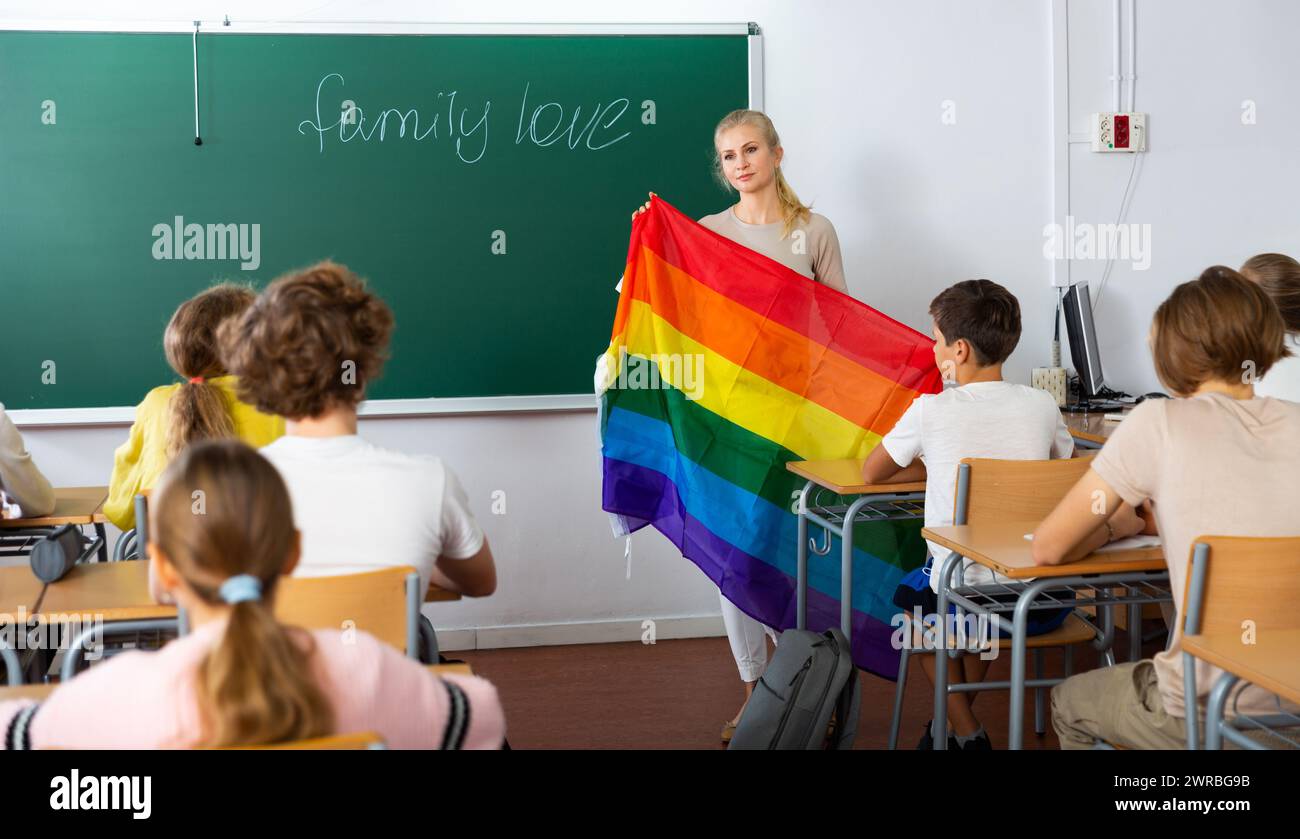 Teacher explaining LGBT flag meaning for kids during lesson Stock Photo ...