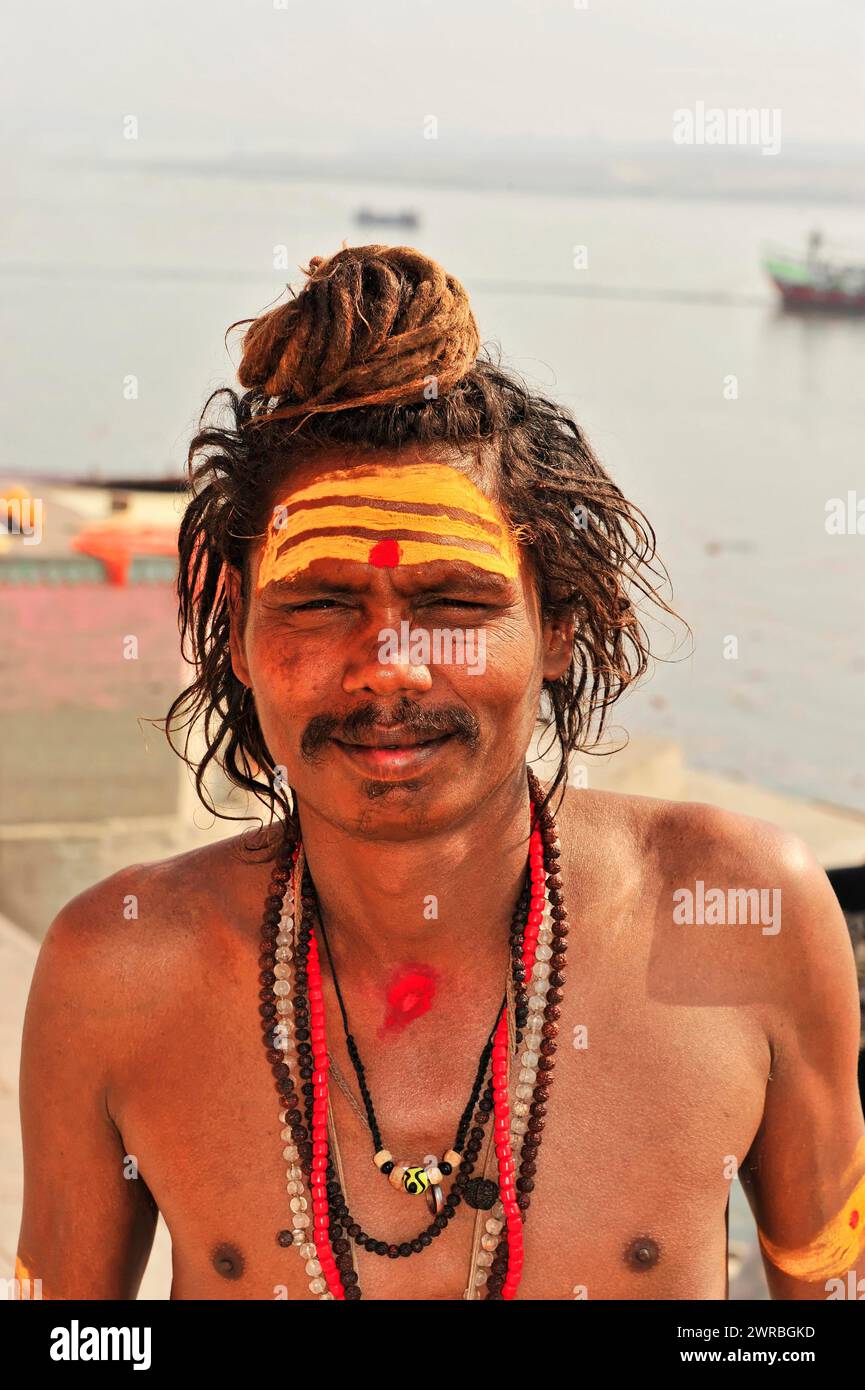 Portrait of a sadhu with face painting and religious symbols in ...