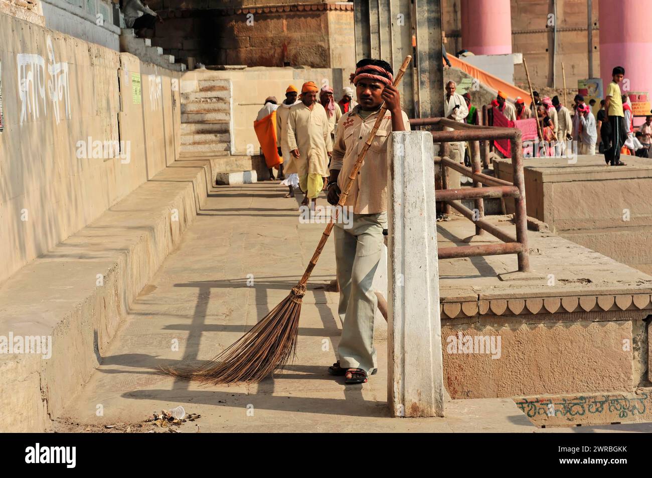 A cleaner sweeps the floor at the ghats of Varanasi in uniform ...