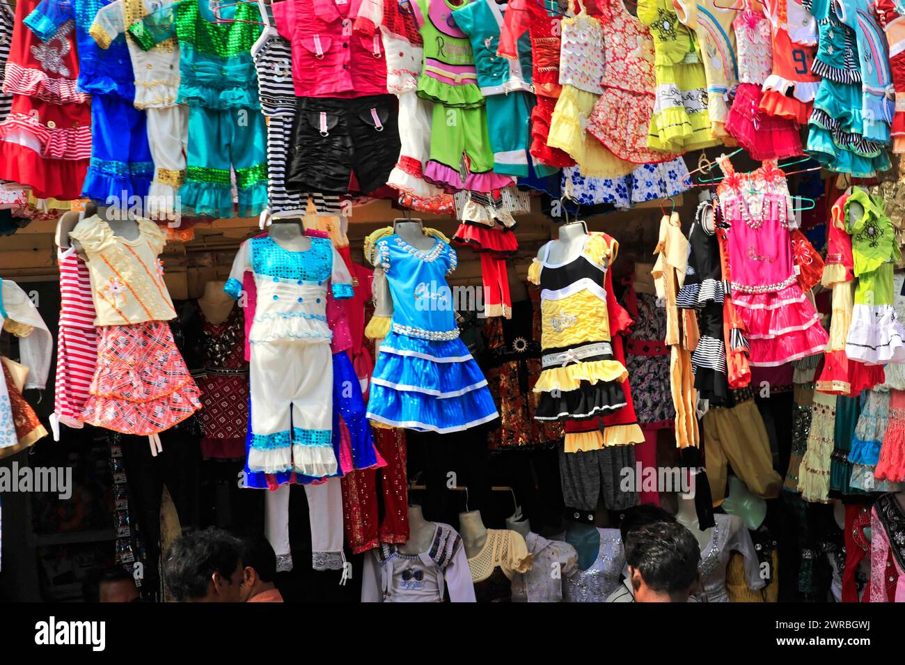Market stall with a selection of colourful children's clothes ...
