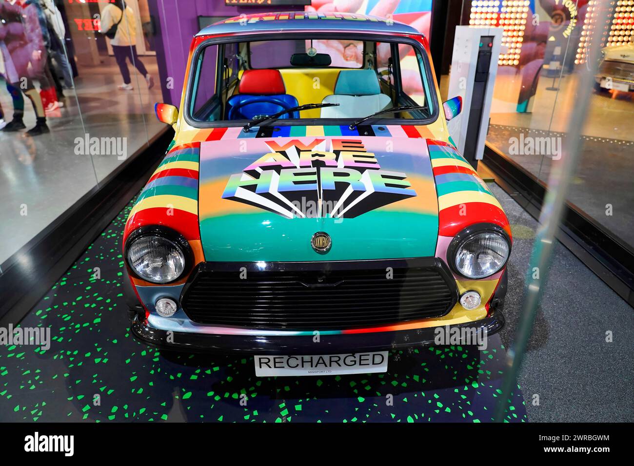 A colourfully designed Mini Cooper stands as an exhibit in a room, BMW ...