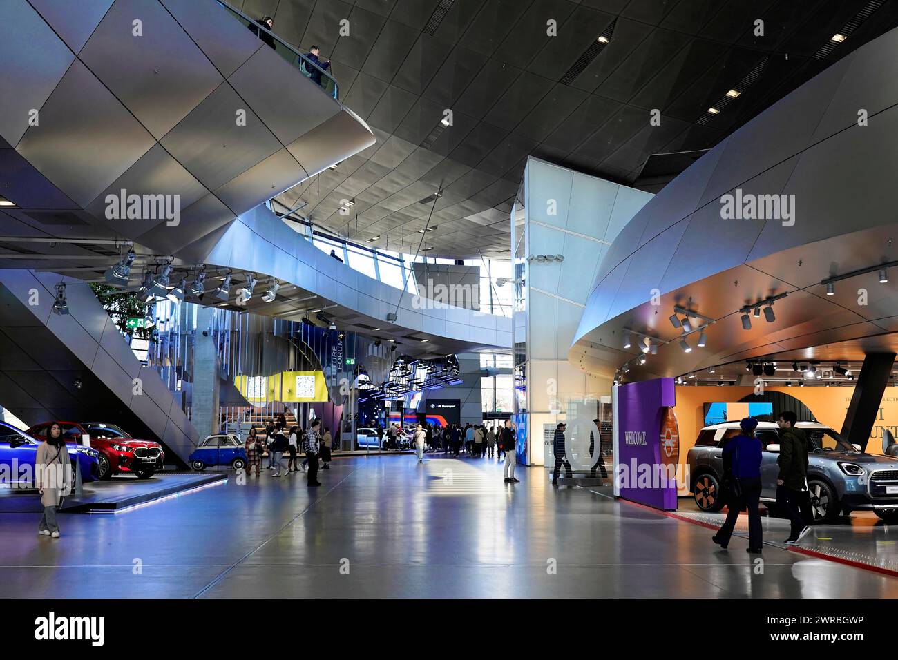 Large exhibition hall with modern vehicles and interactive displays ...