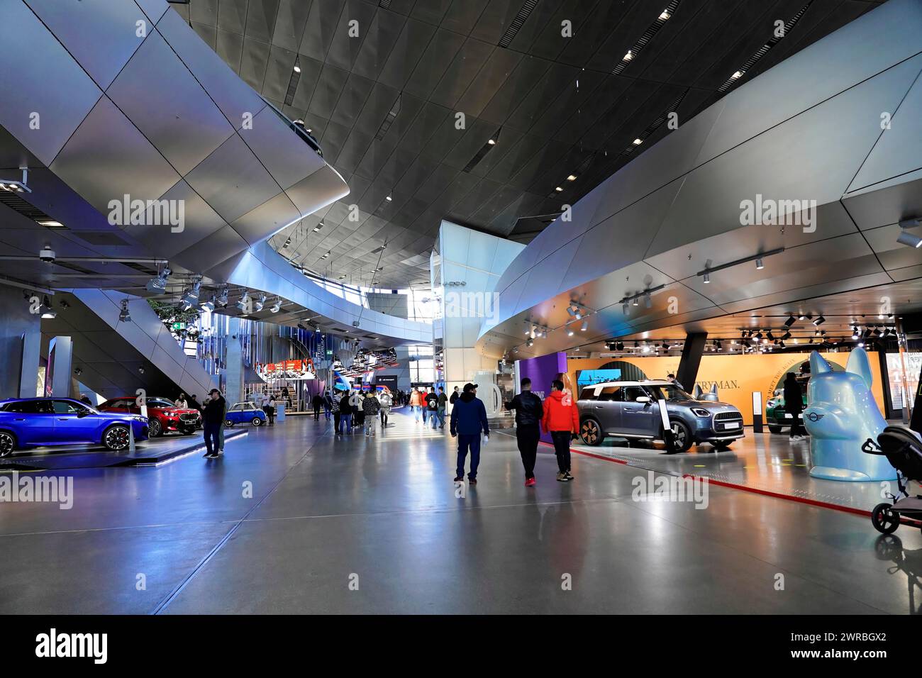 A car exhibition in a spacious hall with several visitors, BMW WELT ...
