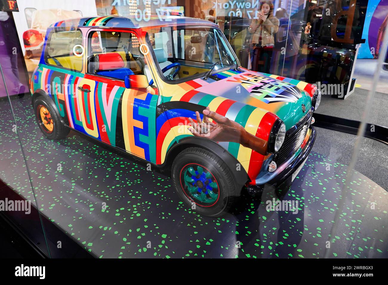 A Mini Cooper with a colourful design and handprints on the bonnet, BMW ...